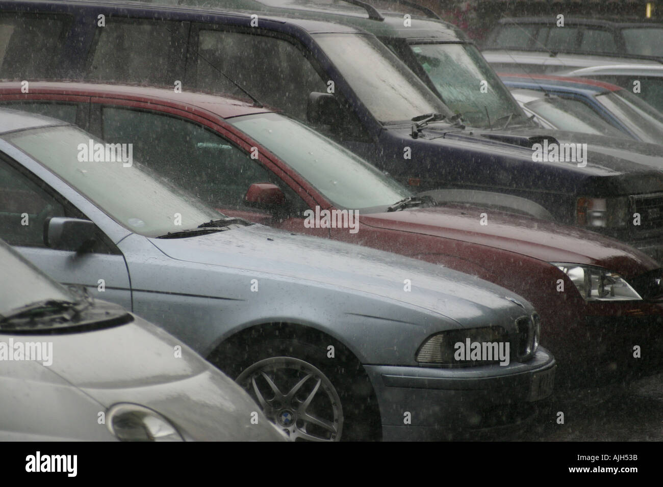 Parked cars in a summer rainstorm in Devon uk Stock Photo - Alamy