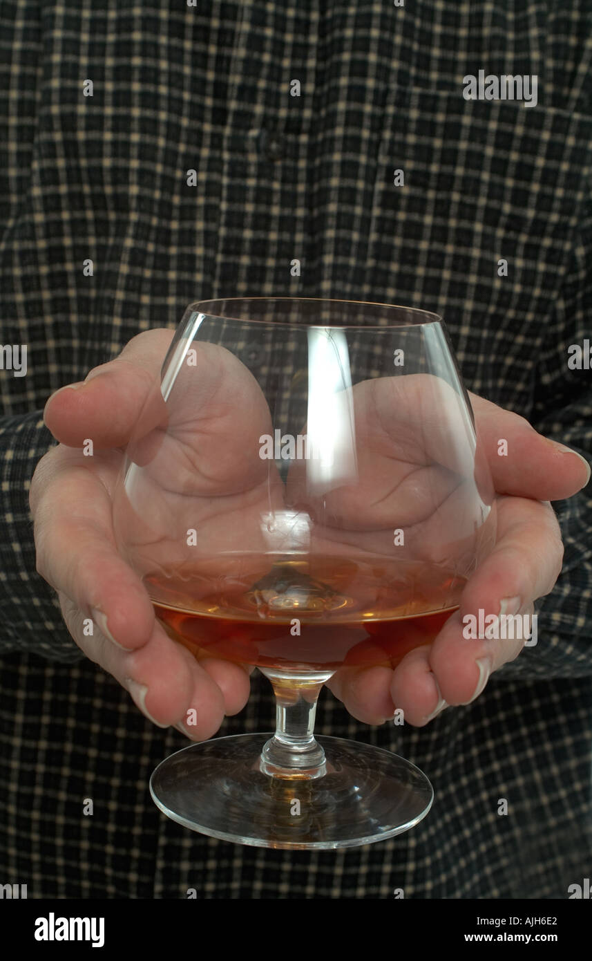 hand holding a glass of brandy cognac Stock Photo - Alamy