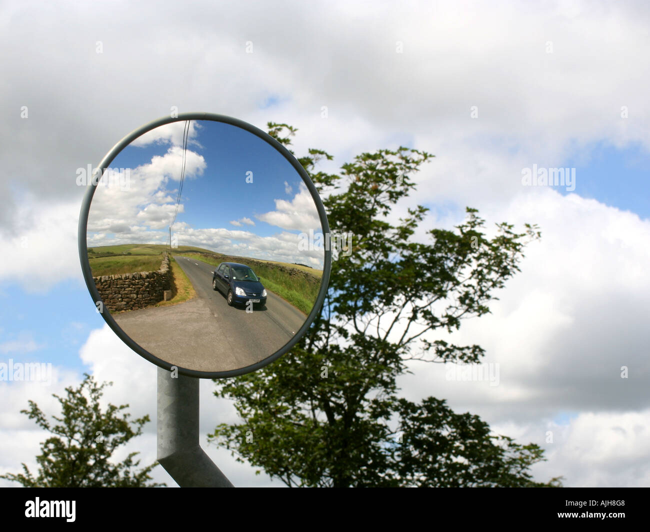 Roadside mirror with car reflection Stock Photo - Alamy