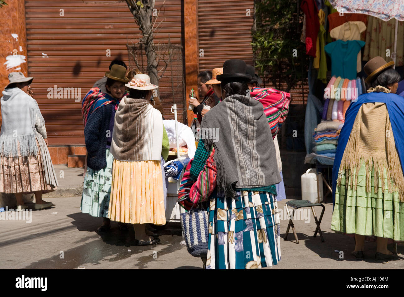 Aymara people and a food stall in the market district of La Paz ...