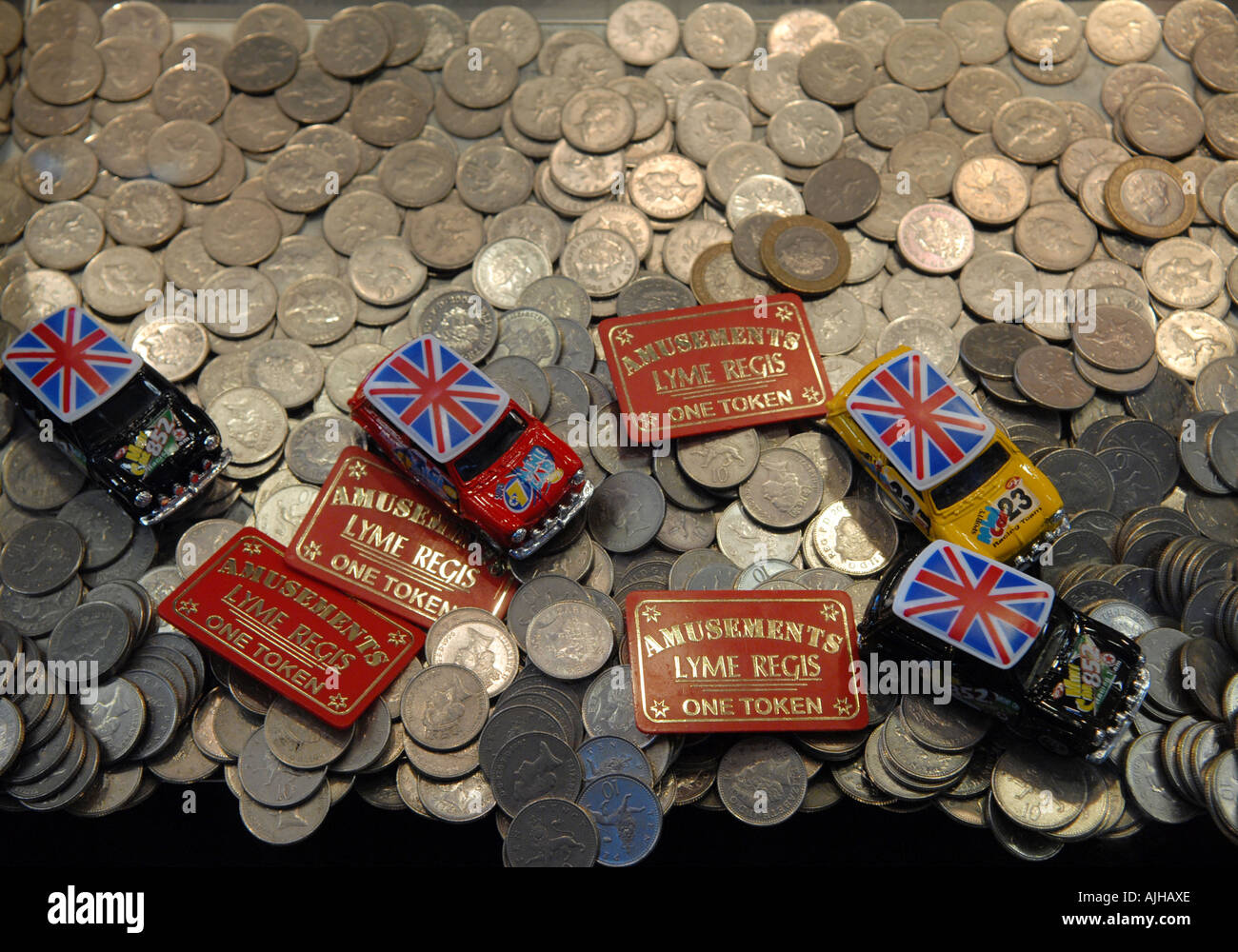 Coins in an amusement arcade, Lyme Regis, UK Stock Photo - Alamy
