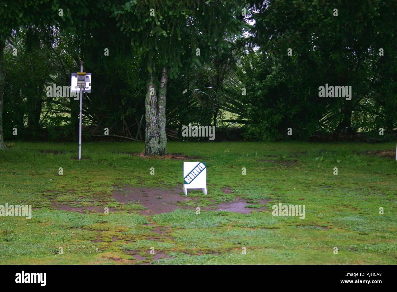 Reserved sign at deserted Camping Place in late evening to assure ...