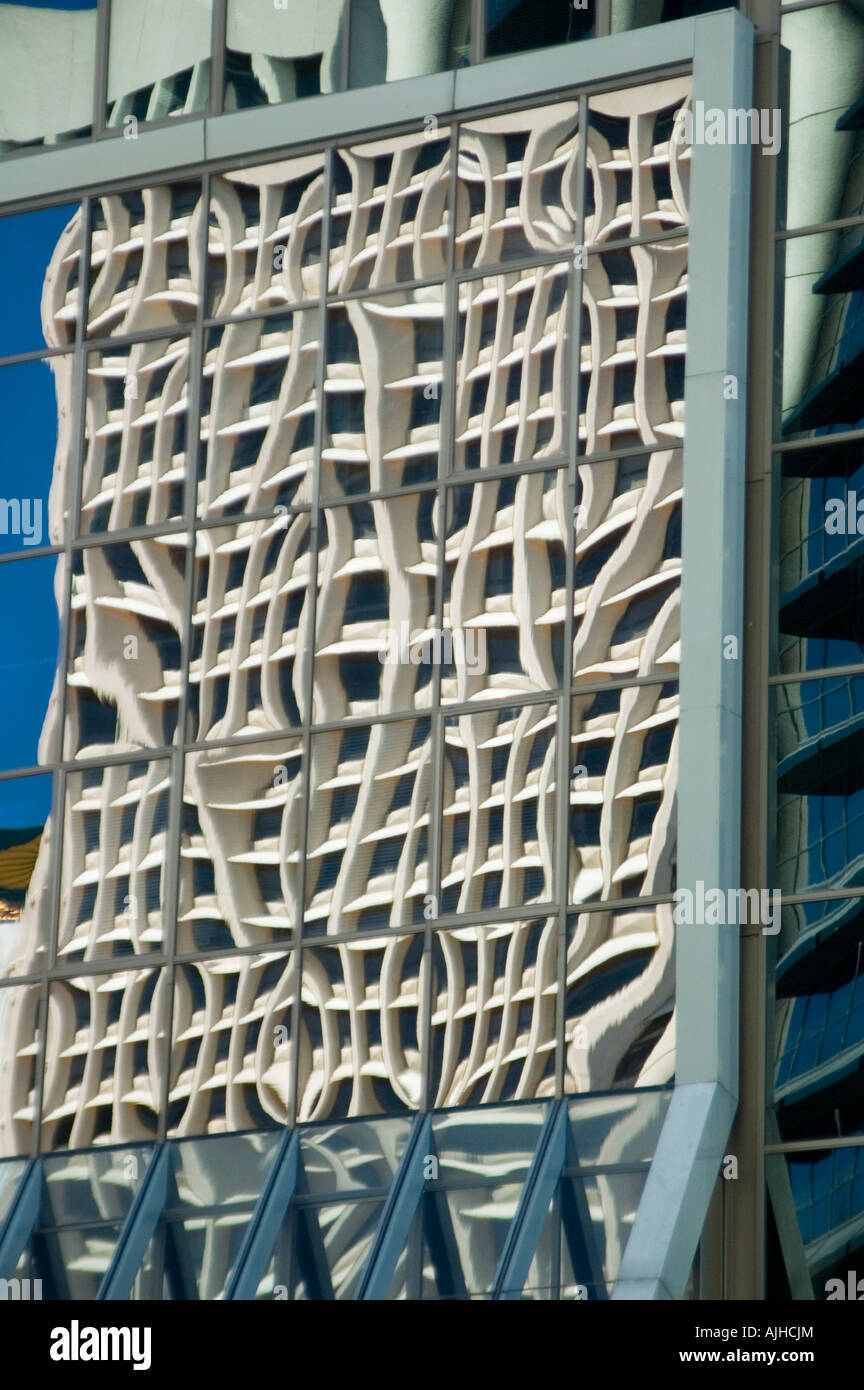 twisted building reflected in glass building Stock Photo - Alamy