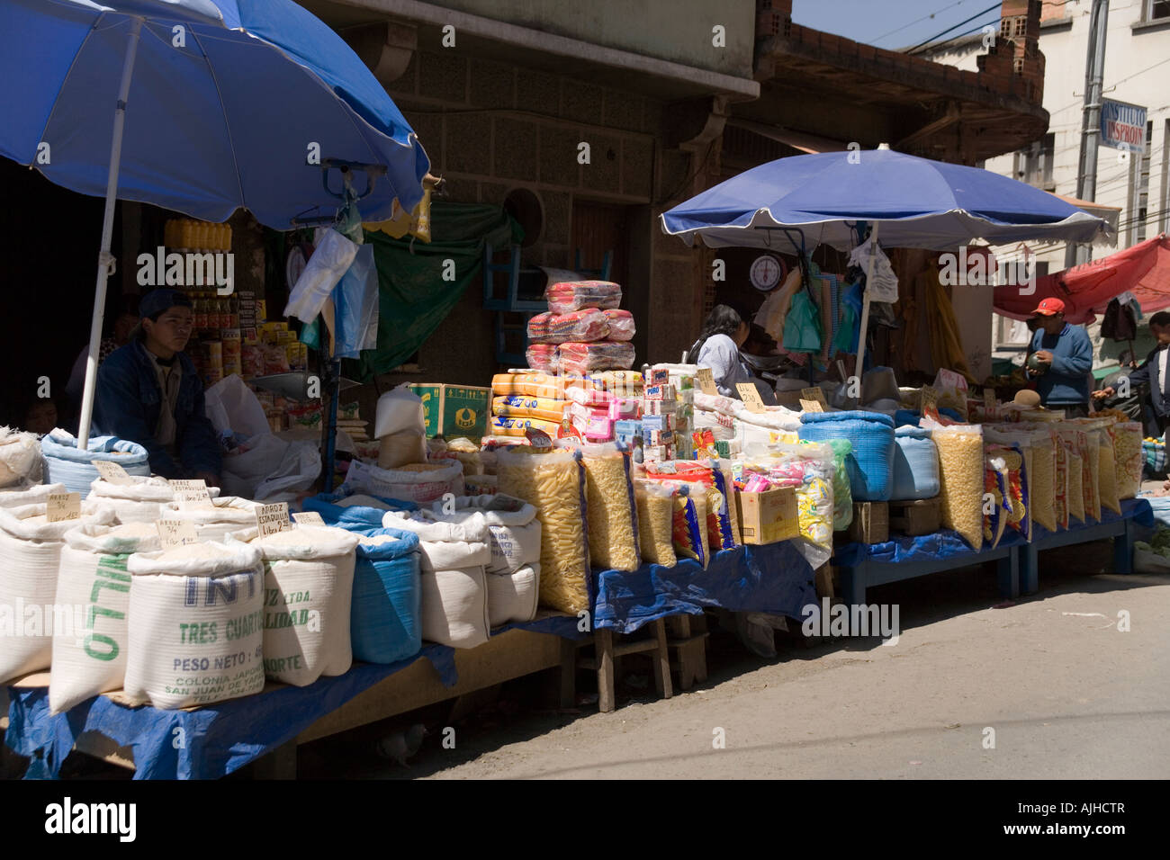 Aymara people and a food stall in the market district of La Paz ...