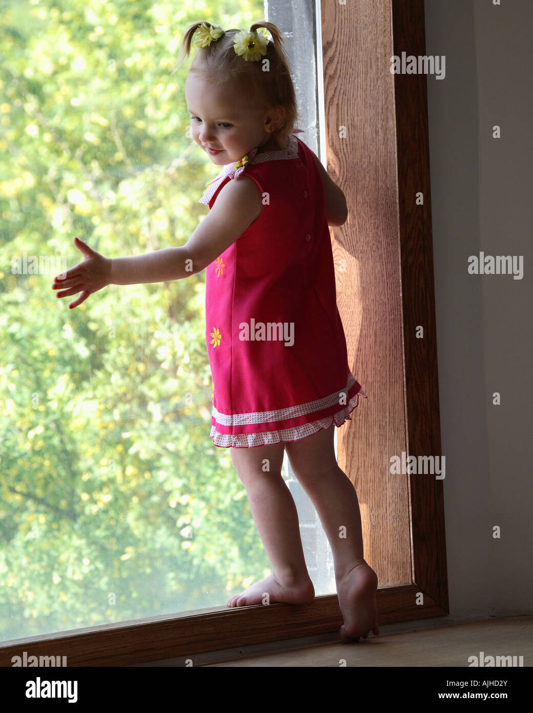 Young girl pressed against window Stock Photo - Alamy