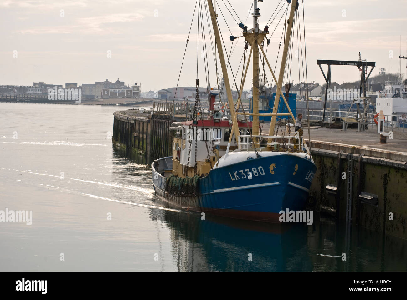 Fishing boat docks quay side Stock Photo - Alamy