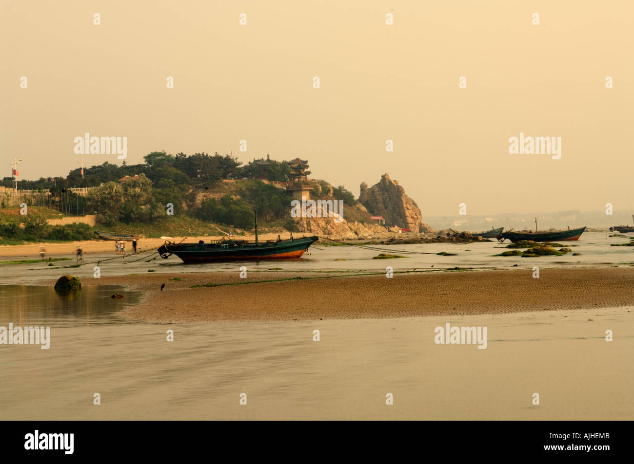 Beidaihe beach on Bo Hai Sea with fishing boats at sunrise in Hebei ...