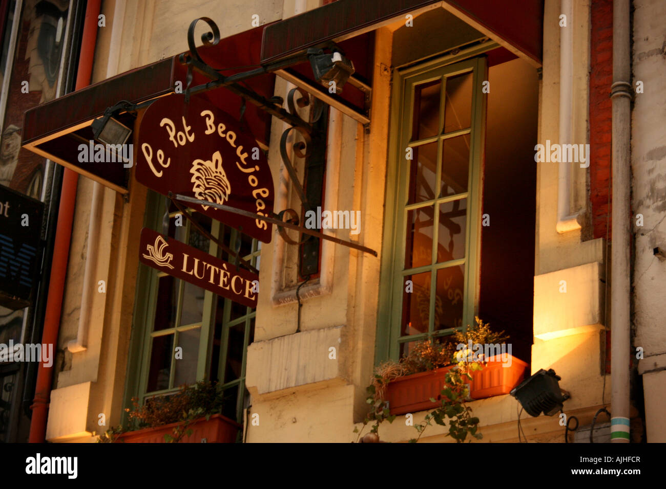 Night time in Lille with old shop sign illuminated under lights, France ...
