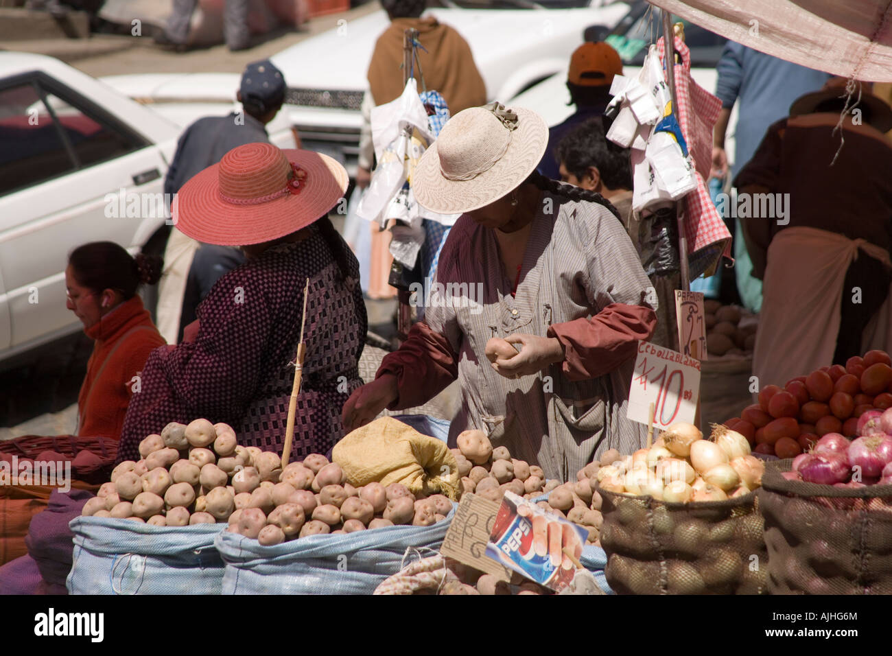 Aymara people and a food stall in the market district of La Paz ...