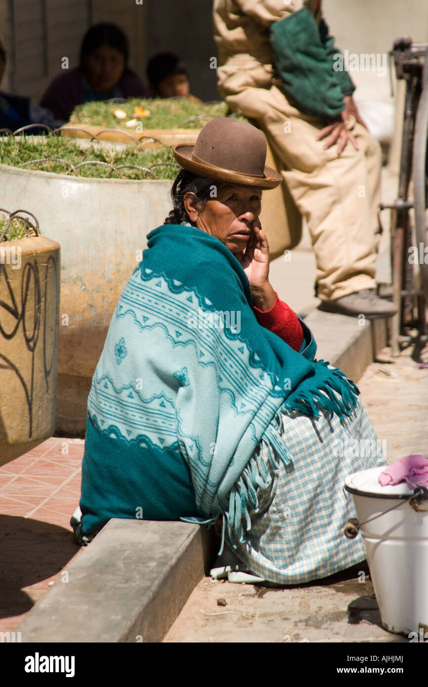 Aymara woman waiting in the street in the market district of La Paz ...