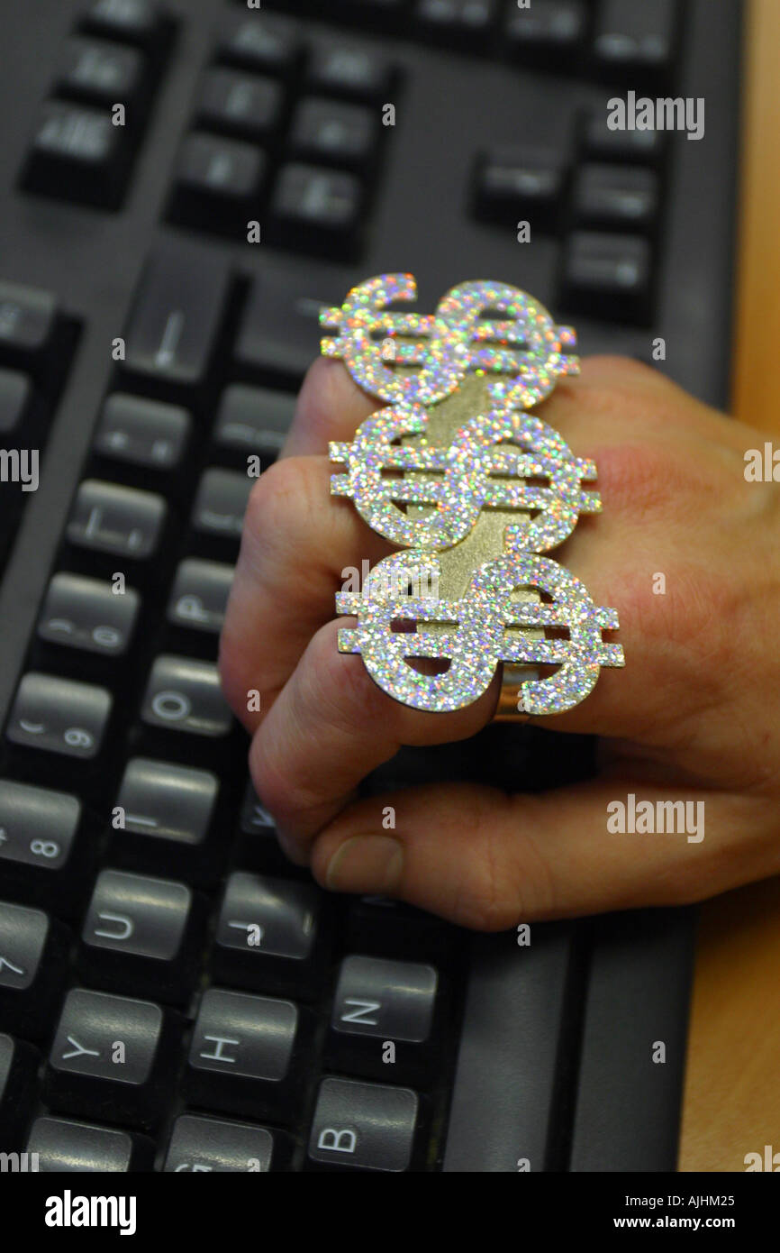 Dollar sign ring on hand of office worker with computer keyboard Stock ...
