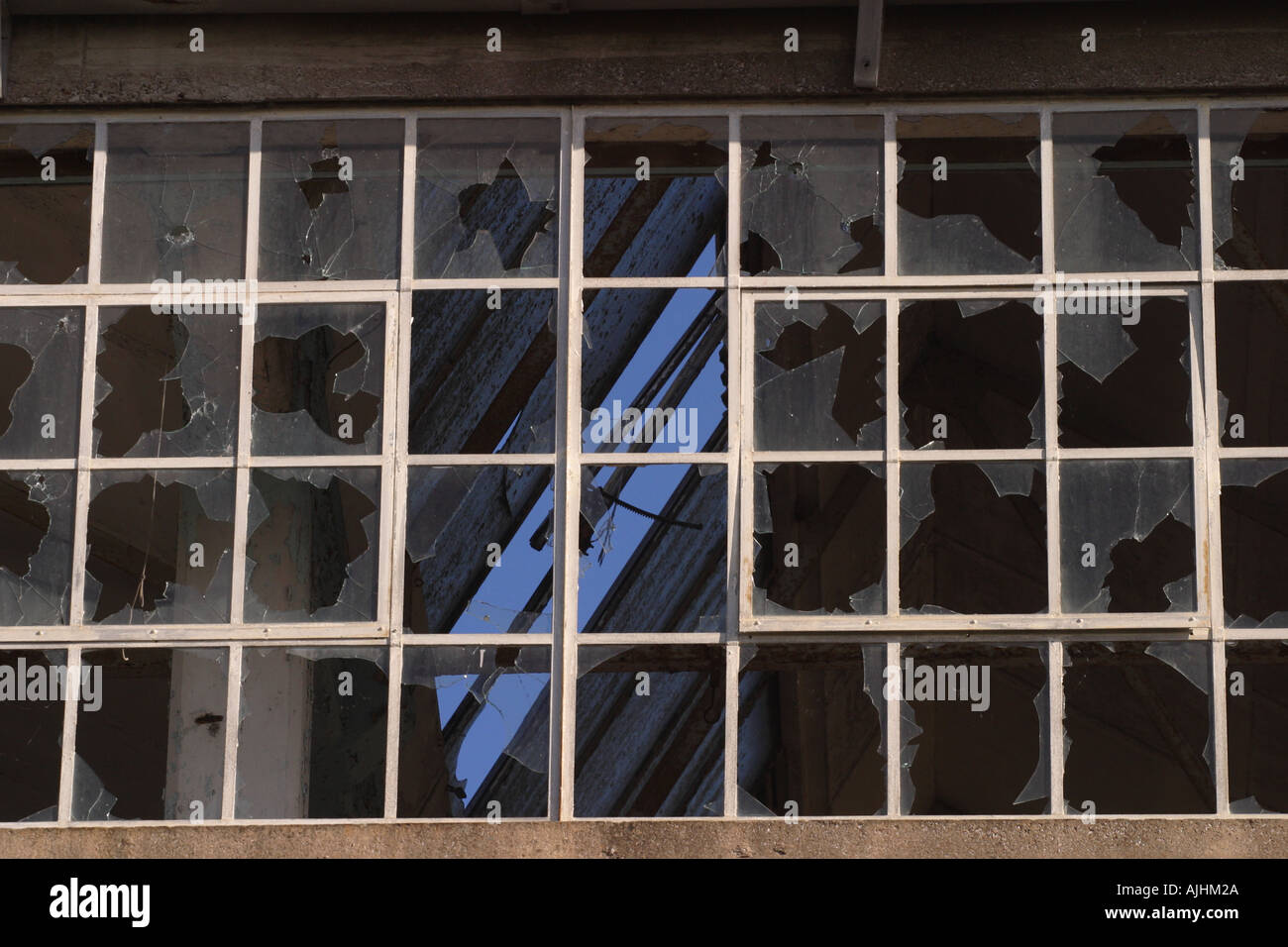 Smashed windows in derelict industrial factory building Stock Photo - Alamy