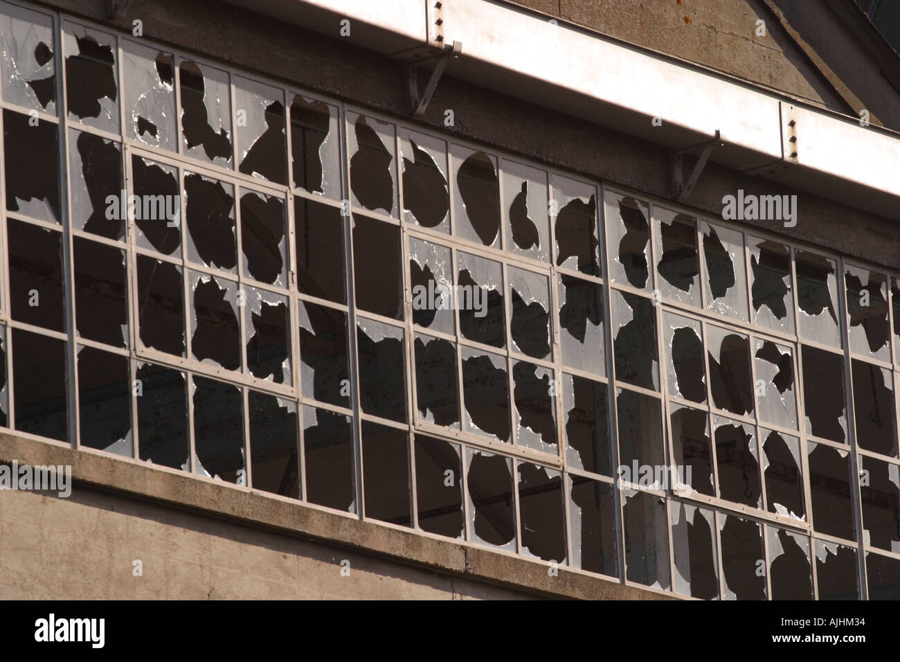 Smashed windows in derelict industrial factory building Stock Photo - Alamy