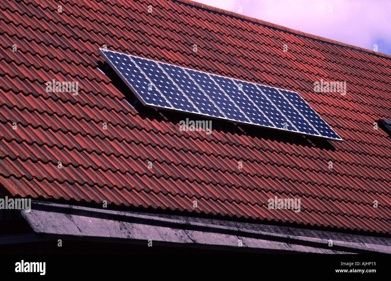 A UK domestic house roof with early solar panels, UK Stock Photo - Alamy