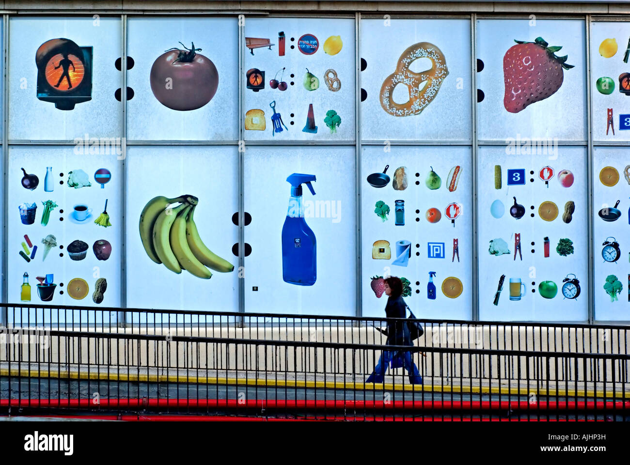A person walking in front of a large retail store window with icons of ...