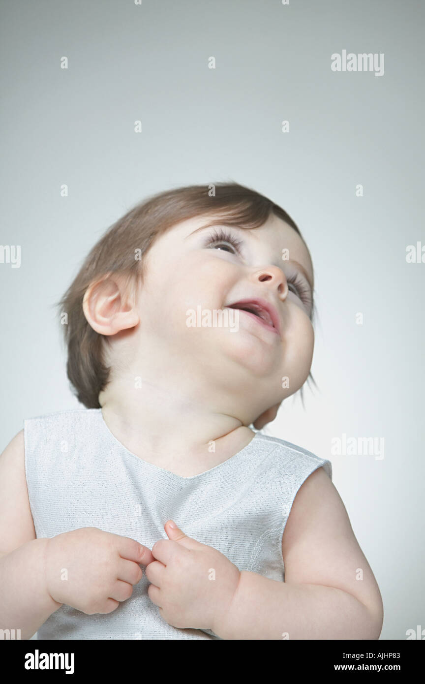 Baby girl looking up Stock Photo - Alamy