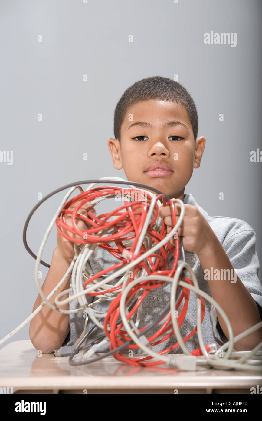 Boy holding electrical cables Stock Photo - Alamy