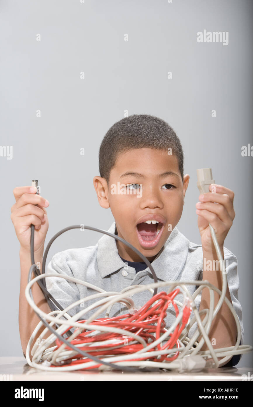 Boy with tangled cables Stock Photo - Alamy