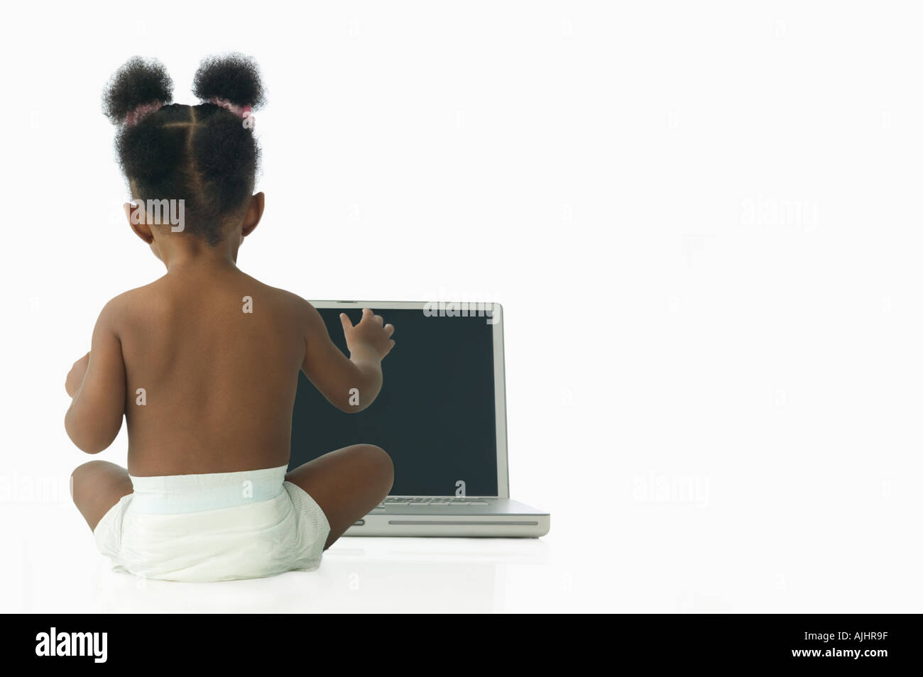 Baby girl with laptop computer Stock Photo - Alamy