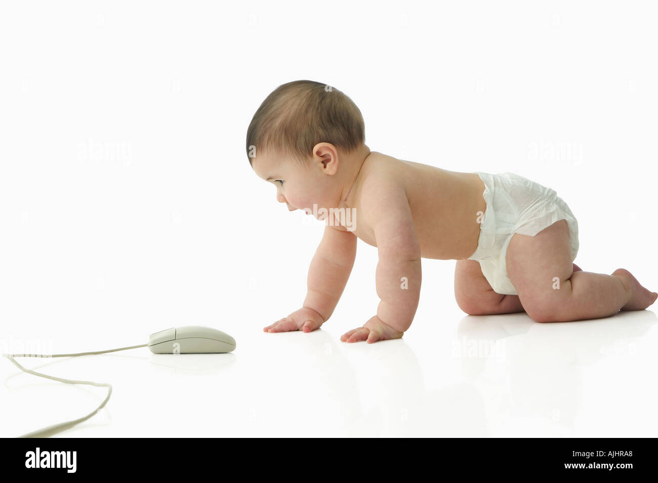 Baby with computer mouse Stock Photo - Alamy