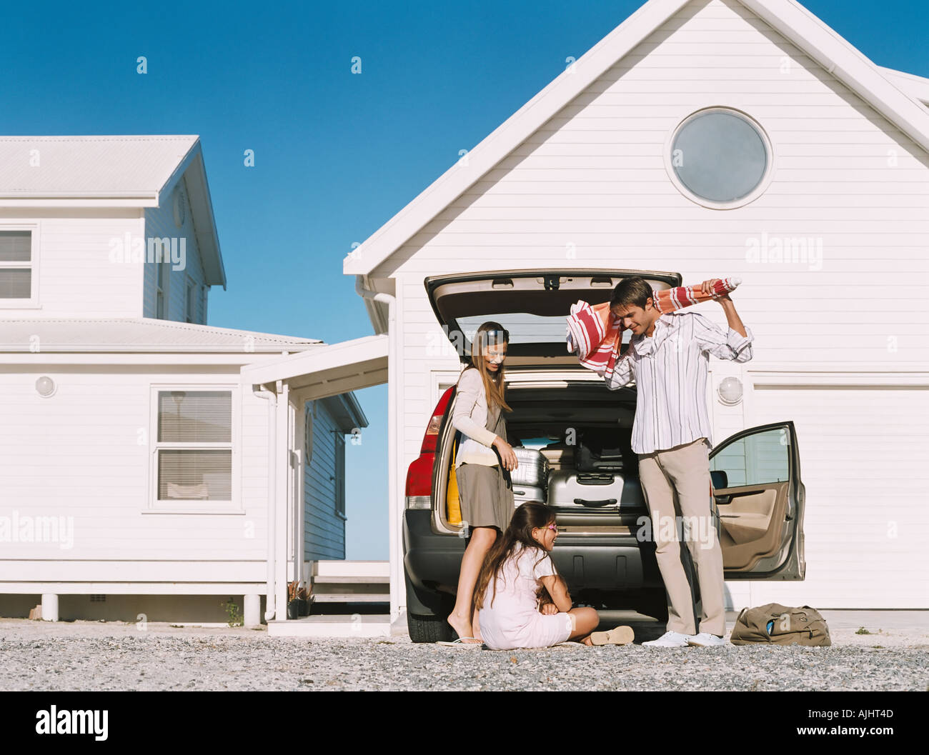 Family unpacking their car Stock Photo - Alamy