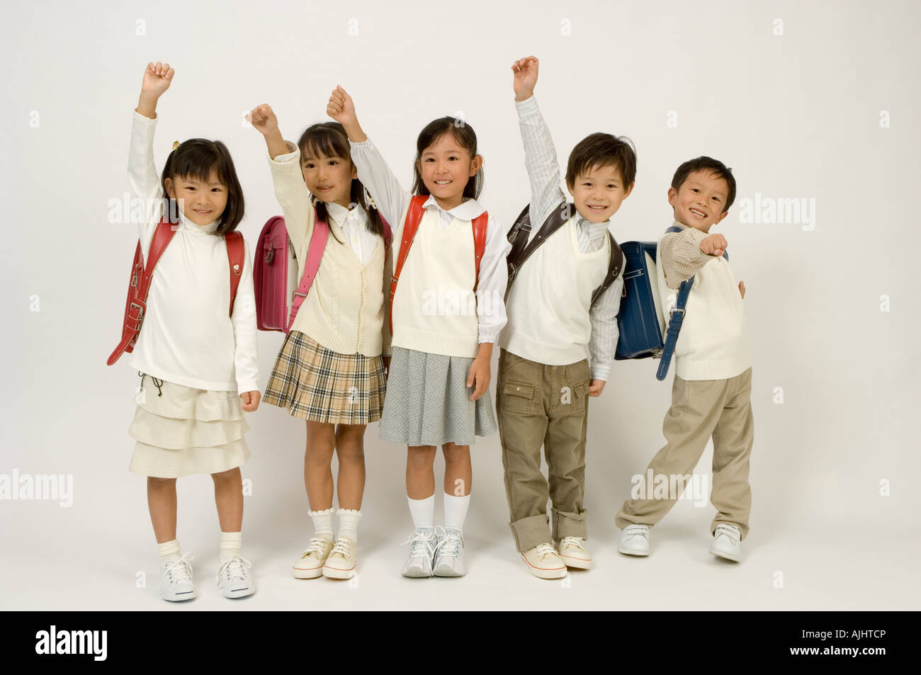 Five elementary age children standing Stock Photo - Alamy