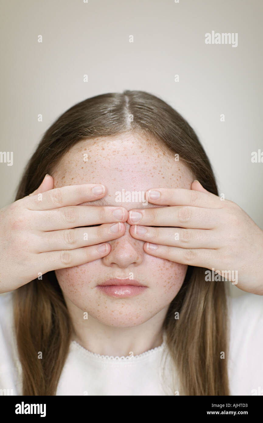 Girl covering her eyes Stock Photo - Alamy