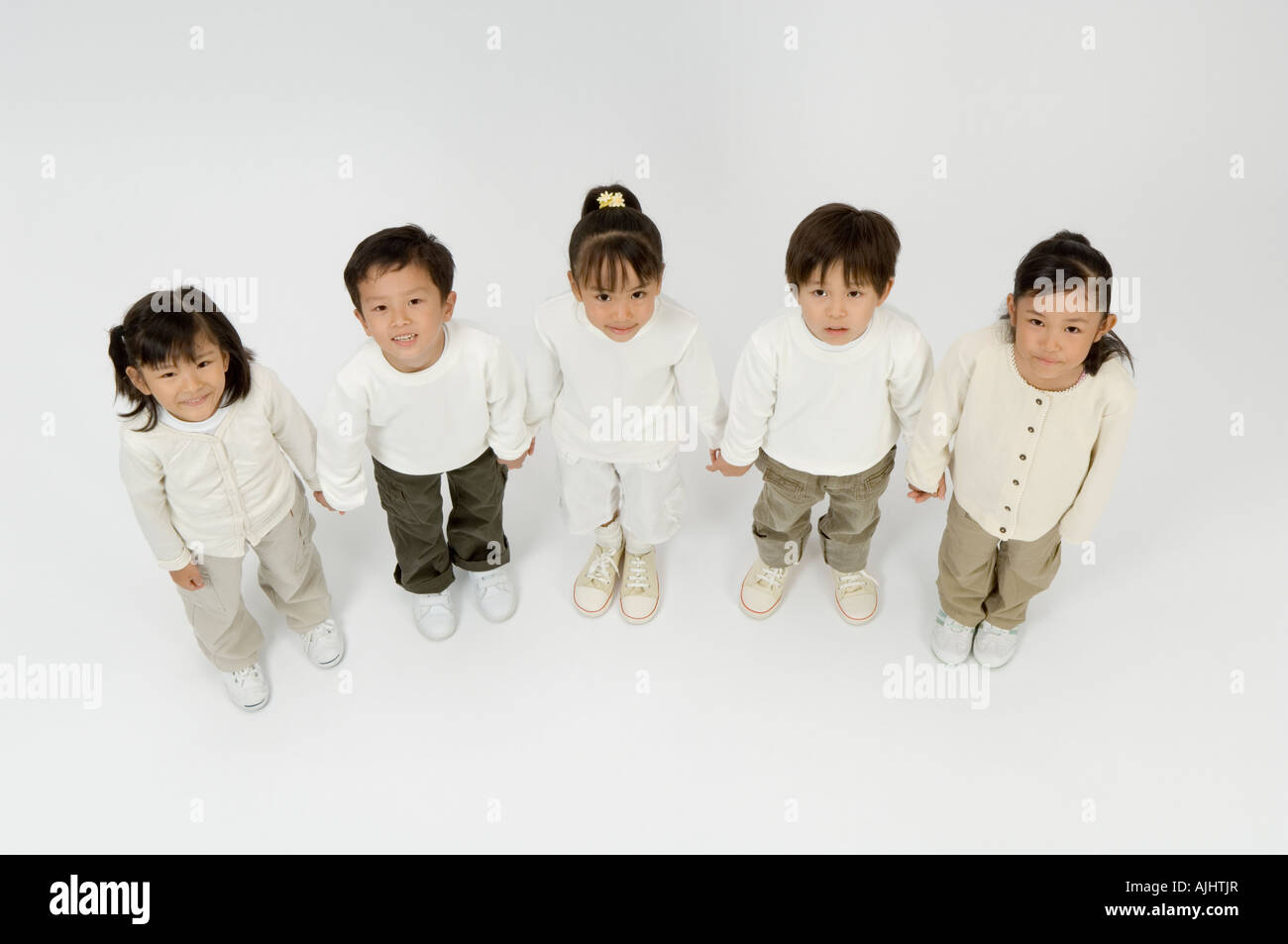 Five elementary age children standing Stock Photo - Alamy