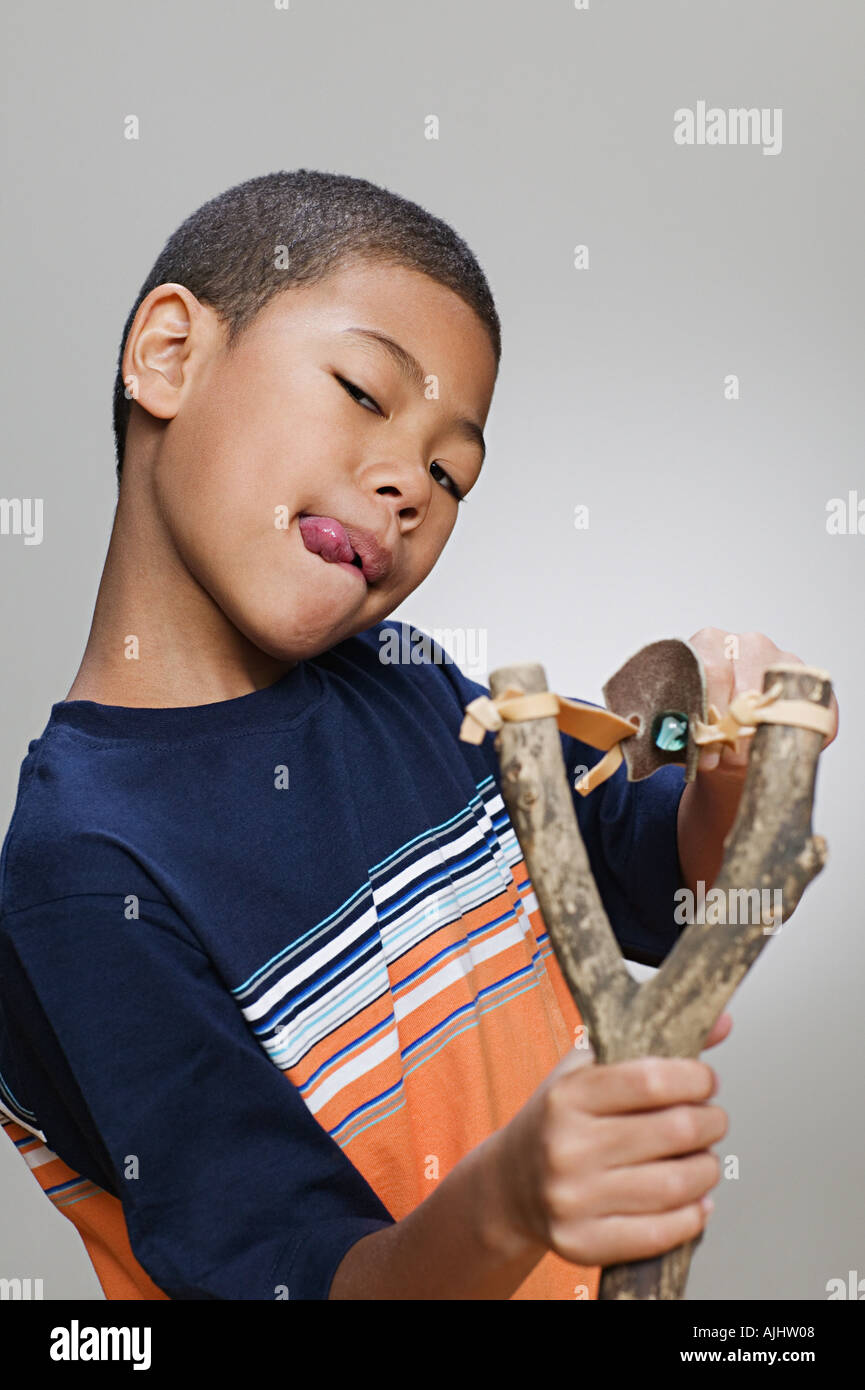 Boy using a catapult Stock Photo - Alamy
