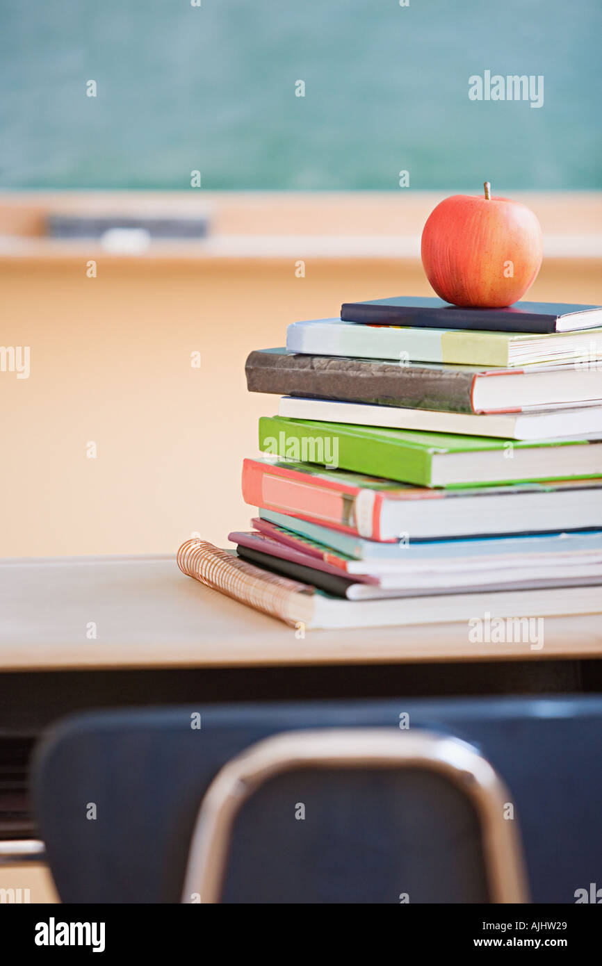 Apple on a stack of books Stock Photo - Alamy