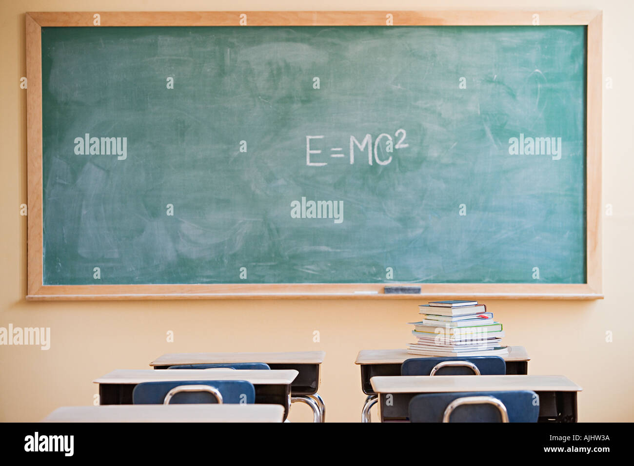 Textbooks and blackboard in classroom Stock Photo - Alamy