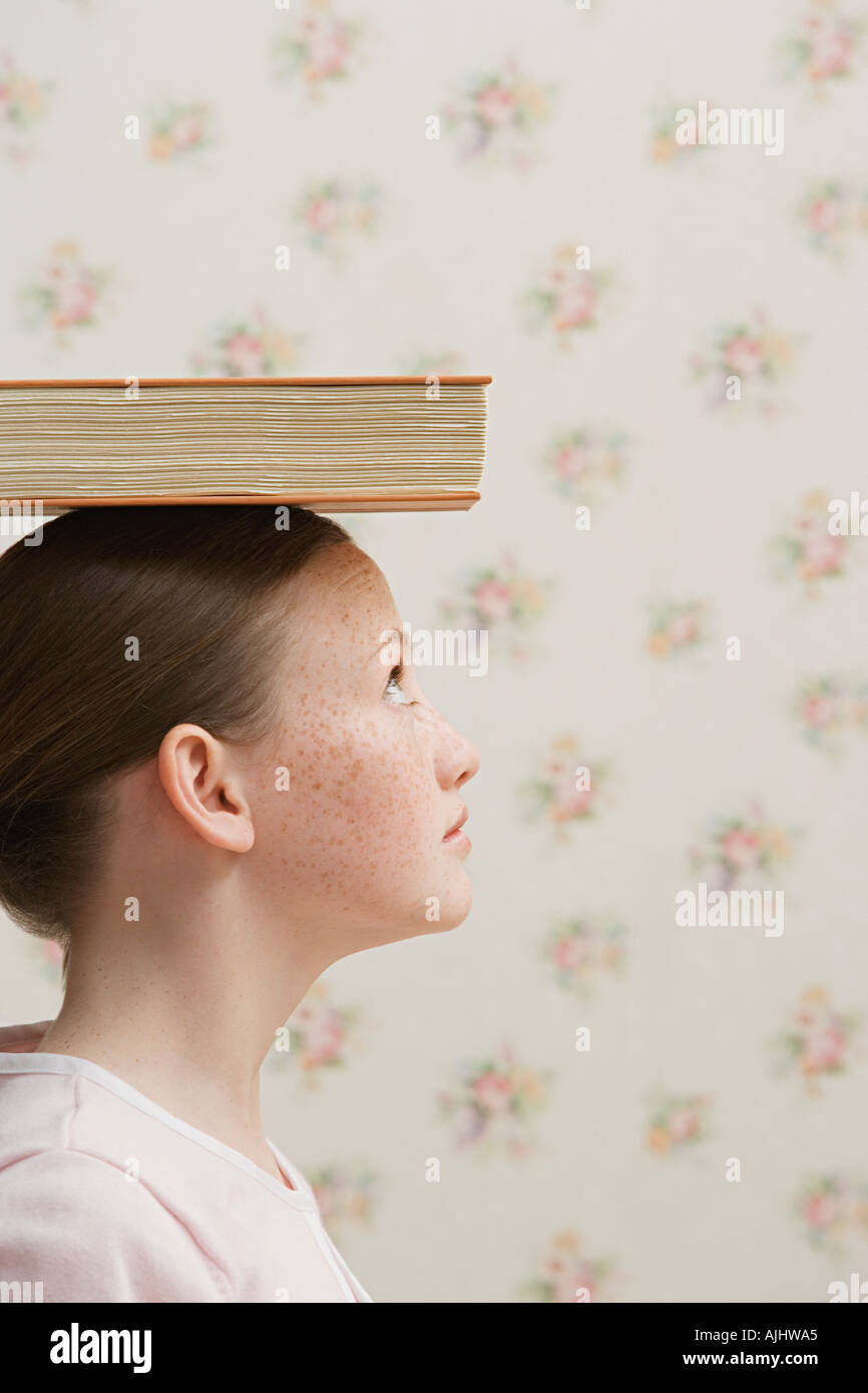 Girl balancing book on head hi-res stock photography and images - Alamy