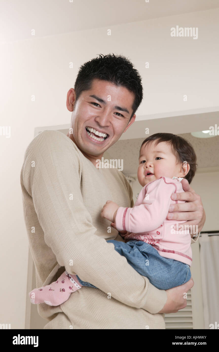 Father carrying baby Stock Photo - Alamy