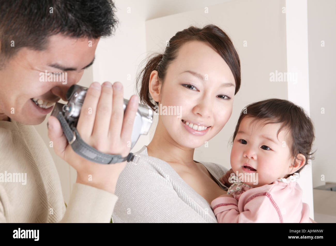 Father filming family with video camera Stock Photo - Alamy