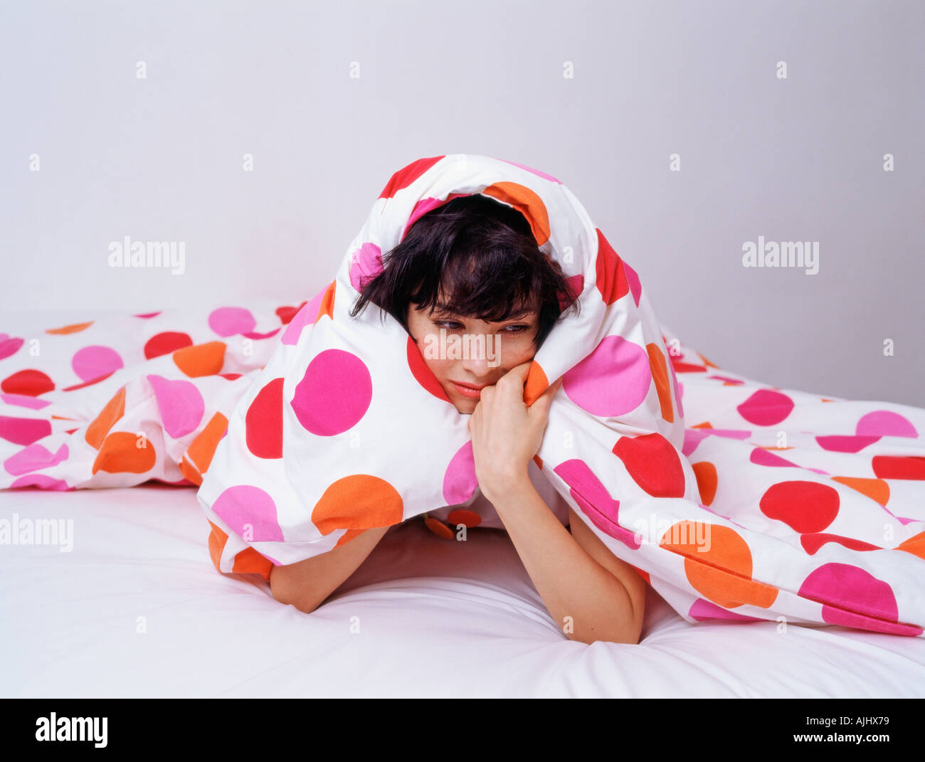 Woman under her duvet Stock Photo - Alamy