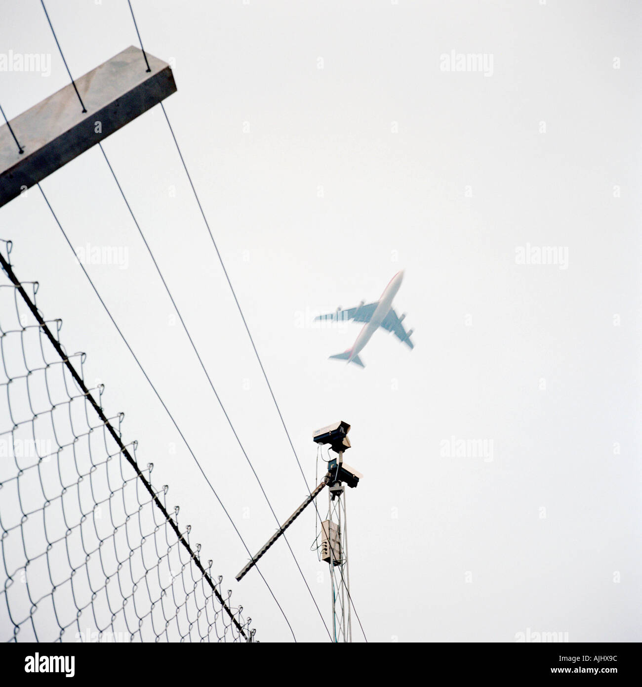 Aeroplane above wire fence Stock Photo - Alamy
