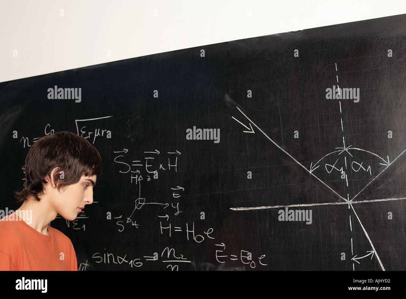 Student looking at equation on blackboard Stock Photo - Alamy