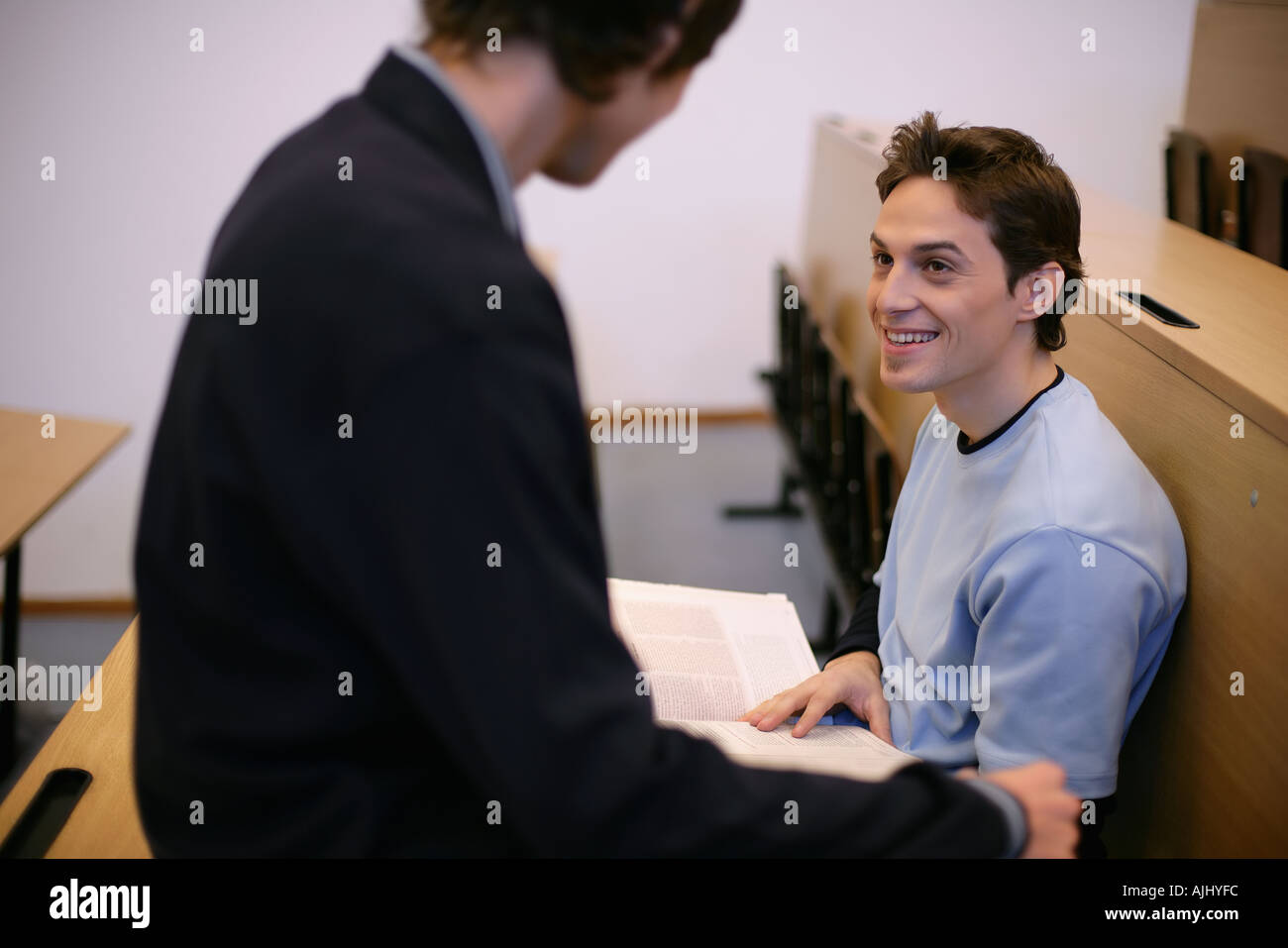 Two young men in a lecture theatre Stock Photo - Alamy