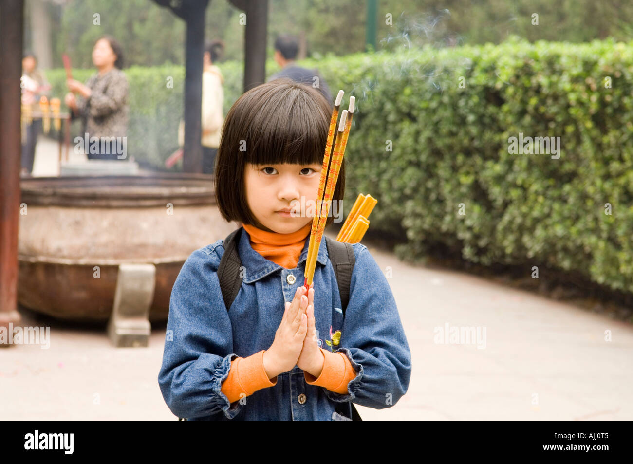 A courtyard pavilion where candles are lit crowded with pilgrims and ...