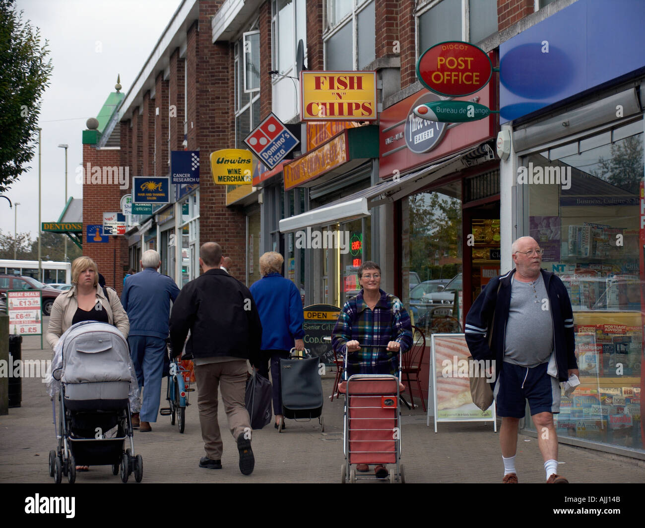 Busy sidewalk and shops on high street in village of Didcot England UK ...