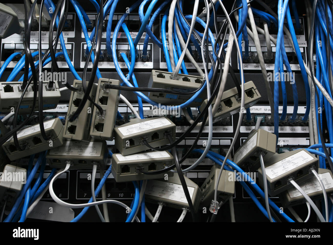chaotic mess of network cables all tangled together Stock Photo - Alamy