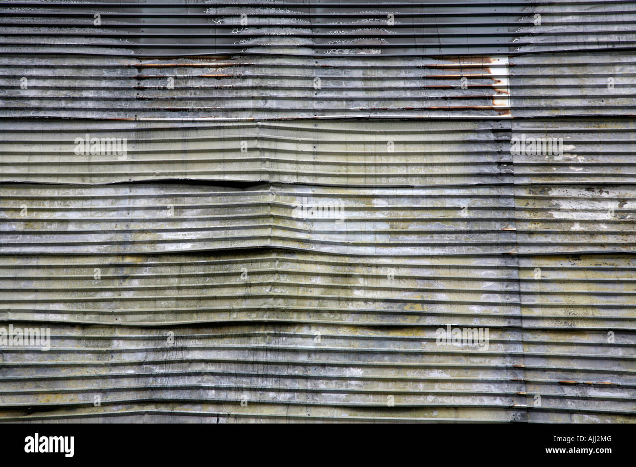 Detail of fire-damaged cladding to disused and burnt-out factory ...