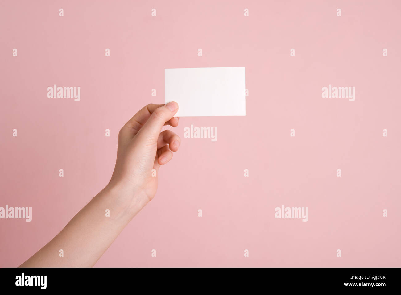 Woman's hand holding card Stock Photo - Alamy