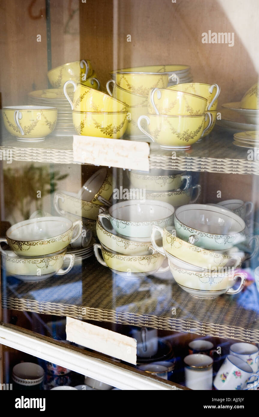 Stacked china and crockery in glass fronted cupboard of 17th century ...
