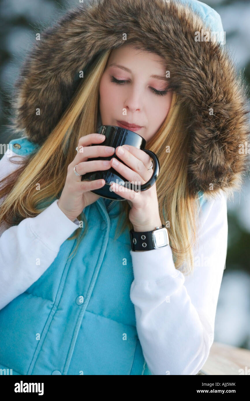 Woman drinking hot drink outside Stock Photo - Alamy