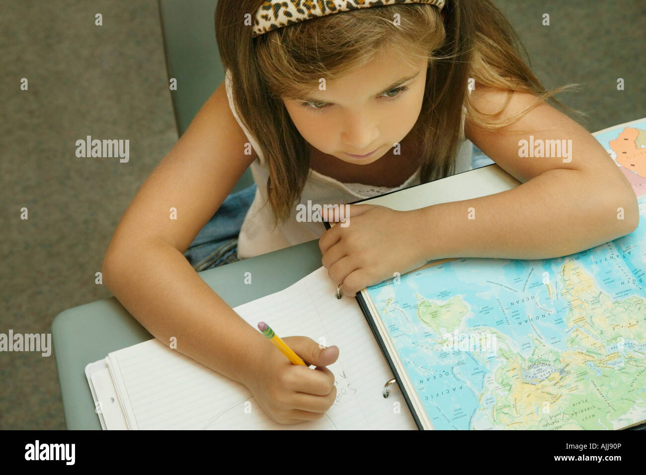 Girl doing work at her desk Stock Photo - Alamy