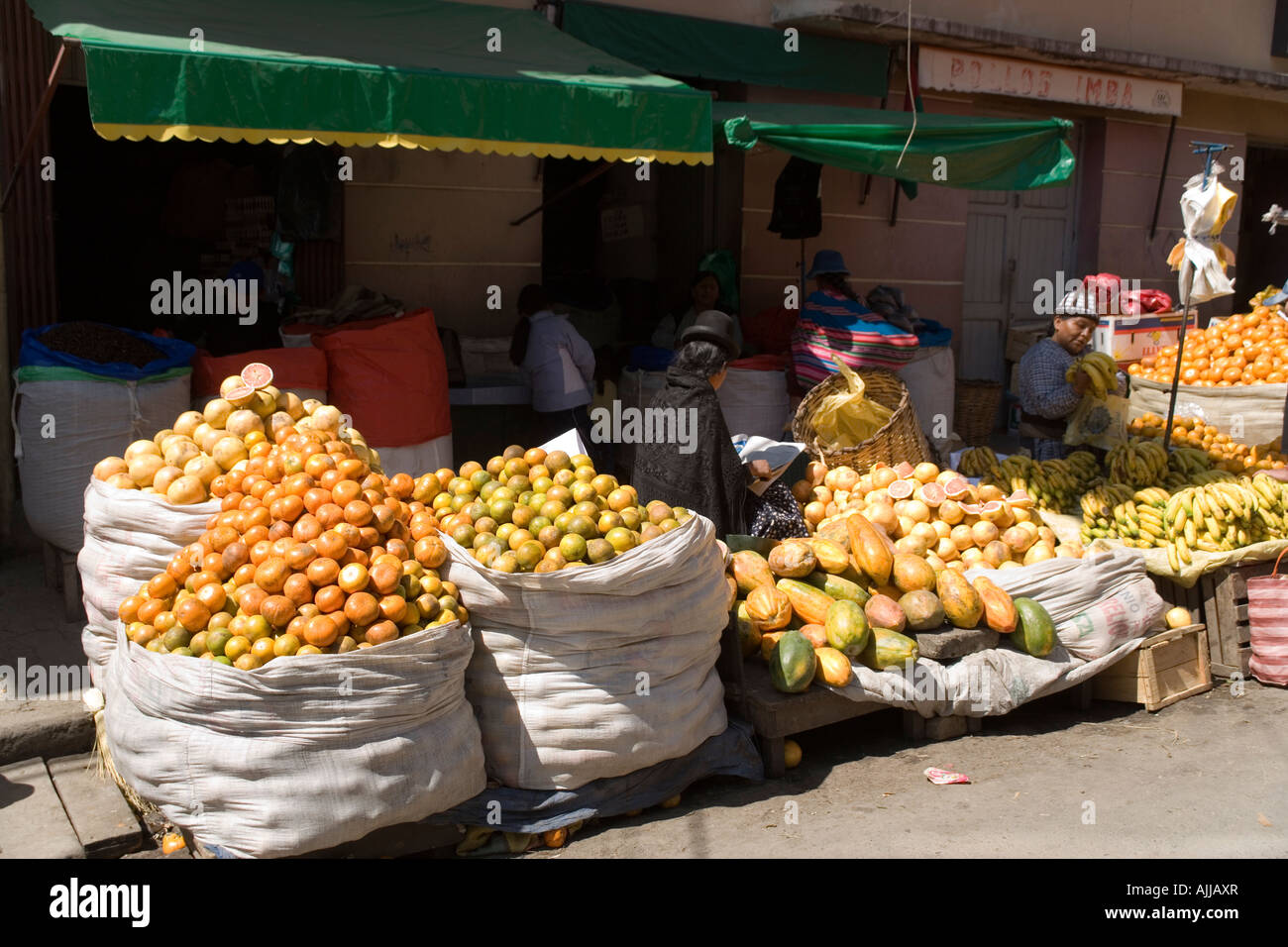Aymara people and a food stall in the market district of La Paz ...
