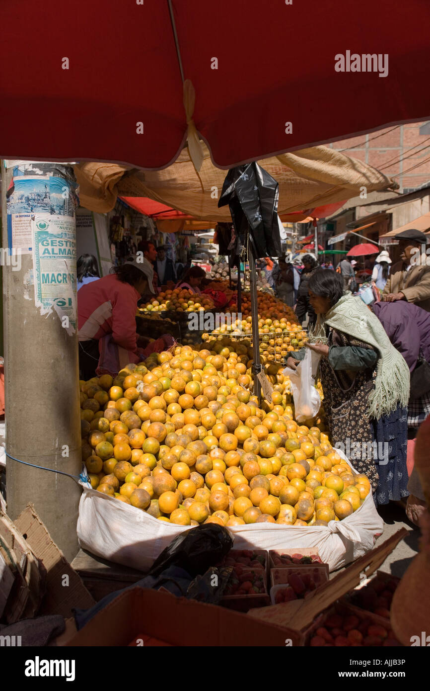 Aymara people and a food stall in the market district of La Paz ...