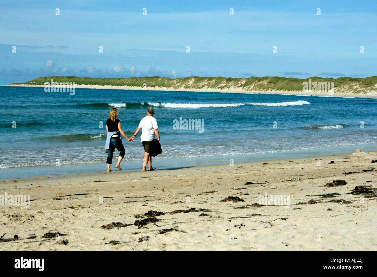 Couple hand in hand at Magheroarty Spit beach, Donegal, Ireland Stock ...