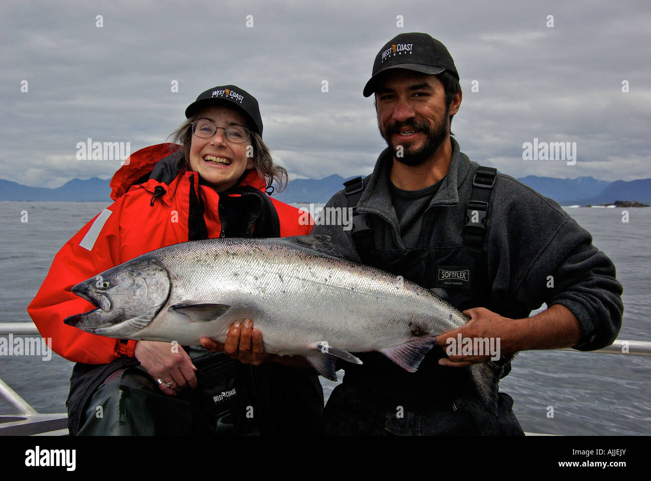 Happy angler with her guide holding her fine Chinook salmon Stock Photo ...